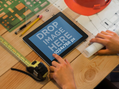 Placeit - Mockup of a Woman Holding an iPad Mini at a Construction Site