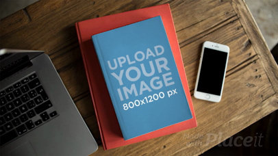 Placeit - Book Moving in Stop Motion on Top of a Red Book on a Table
