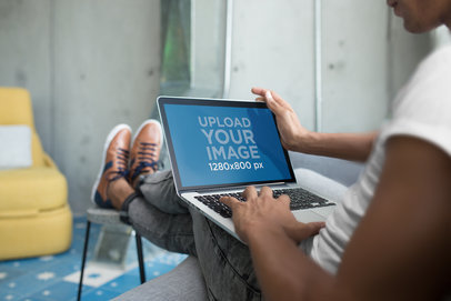 Placeit - Mockup of a Man Using a MacBook at Work