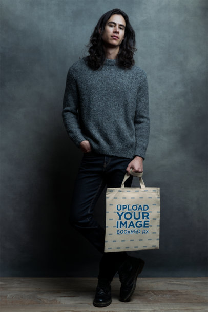 Placeit - Sublimated Tote Bag Mockup Featuring a Man Modeling in a Studio