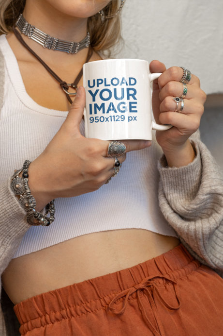Placeit - Mockup of a Woman in Boho Garments Holding an 11 oz Coffee Mug
