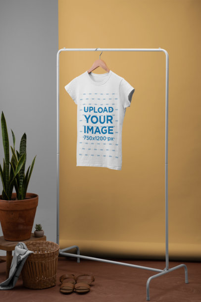 Placeit - Crewneck T-Shirt Mockup Hanged on a Simple Copper Rack
