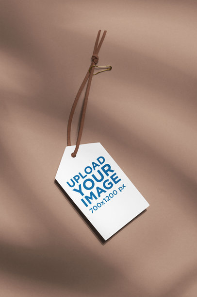 Placeit - Brand Tag Mockup Featuring a Hoodie Placed on a Customizable ...