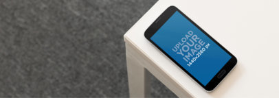 Placeit - Galaxy 4 Mockup Featuring a Woman Sitting on a Striped Couch