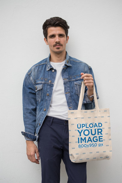 Placeit - Video of a Young Man Holding a Customizable Tote Bag