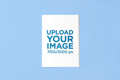 Placeit - Template of a Magazine Lying on a Solid Color Surface