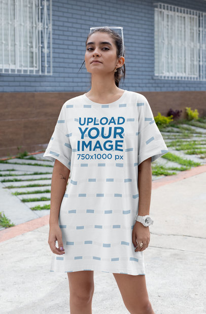 Placeit - Mockup of a Woman Pointing at Her Shift Dress at a Studio