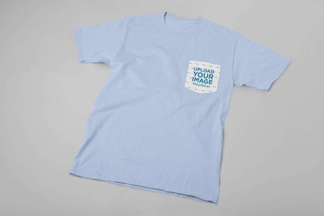 Placeit - Pocket Tee Mockup Lying Flat Against a Solid Surface