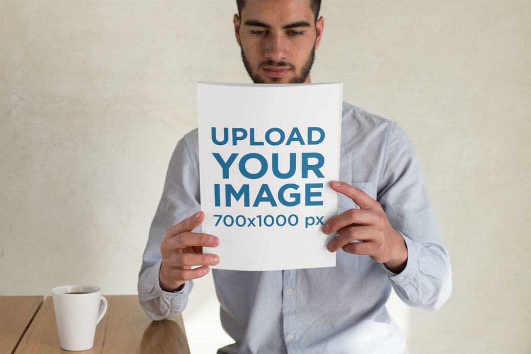 Placeit - Mockup Featuring a Young Man Holding a Magazine