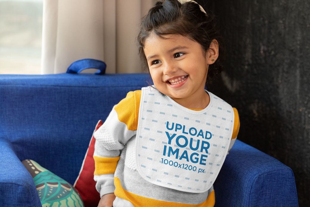 Placeit - Mockup of a Little Girl Wearing a Baby Bib at Home