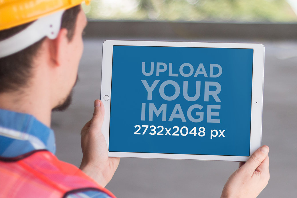 Placeit - Mockup of a Construction Worker Holding an iPad Pro in ...