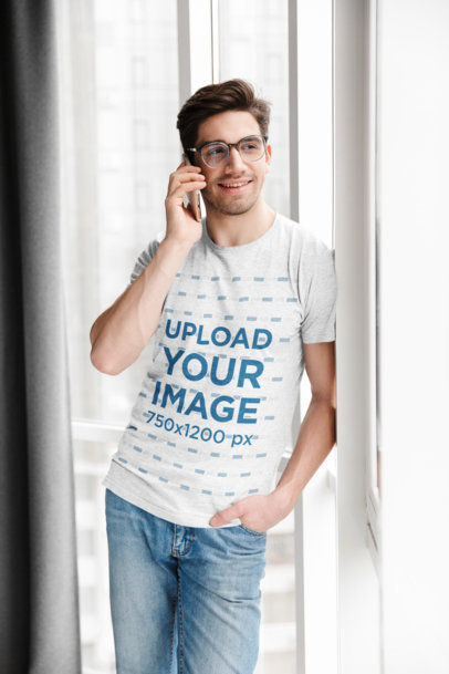 Placeit - T-Shirt Mockup Featuring a Cheerful Man on the Phone