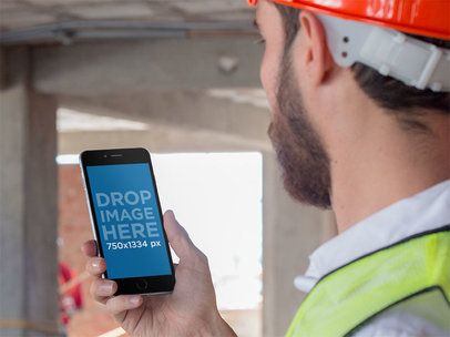 Placeit - Over Shoulder Mockup of a Worker Holding His iPhone in ...
